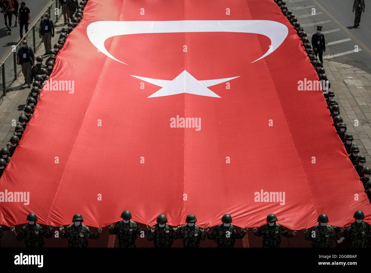 Turkish soldiers march with a Turkish flag during the military parade ...