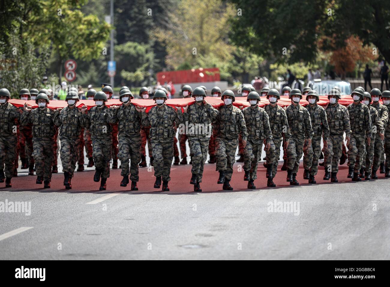 Turkish soldiers march with a Turkish flag during the military parade ...