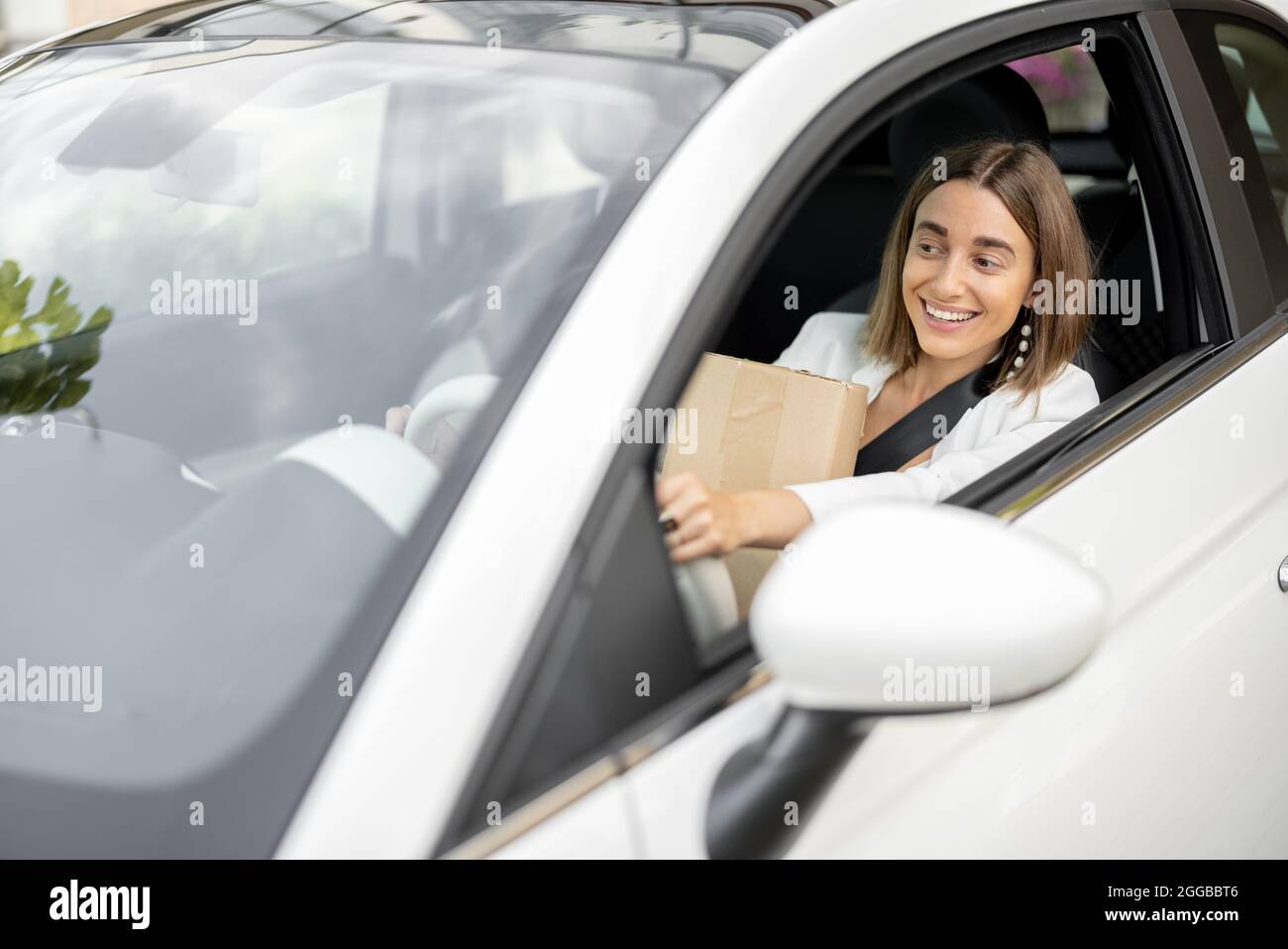 Courier parcels in car hi-res stock photography and images - Alamy