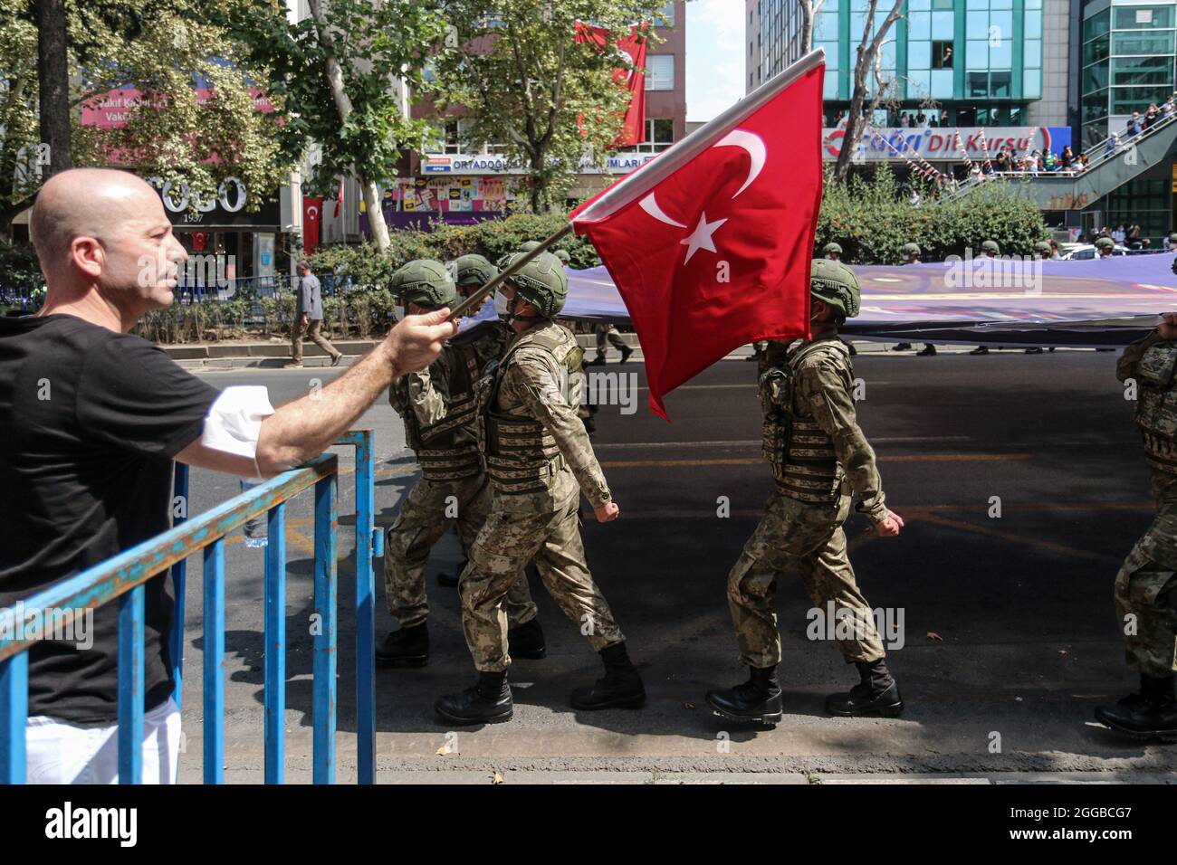 A man is seen waving the Turkish flag during the military parade ...
