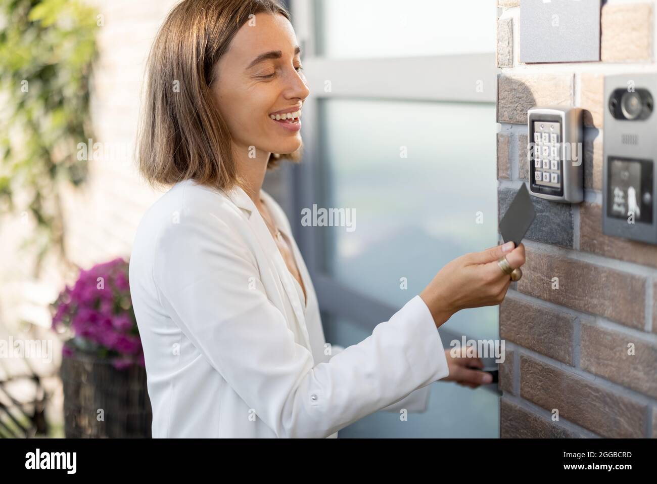 Woman gets access to enter home by card Stock Photo - Alamy