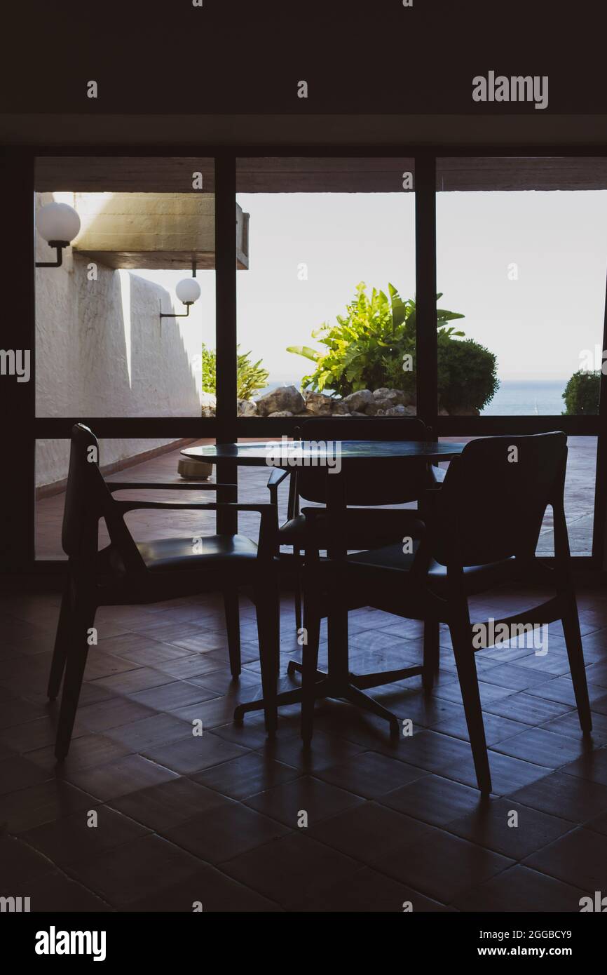 Vertical shot of table and shairs on empty room Stock Photo - Alamy