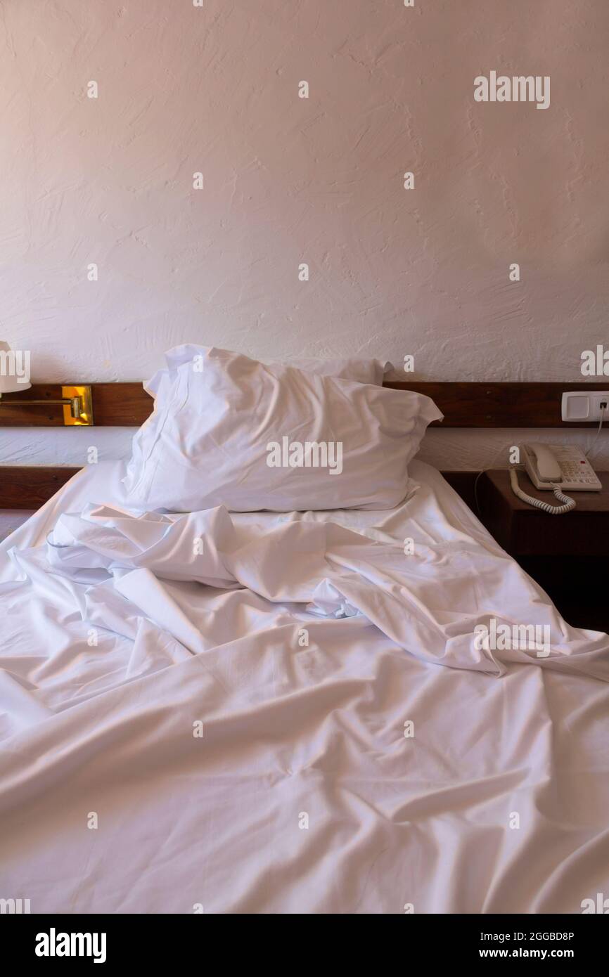Unmade bed on hotel room Stock Photo - Alamy