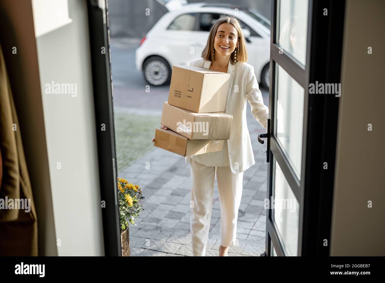 Woman going home with parcels Stock Photo - Alamy