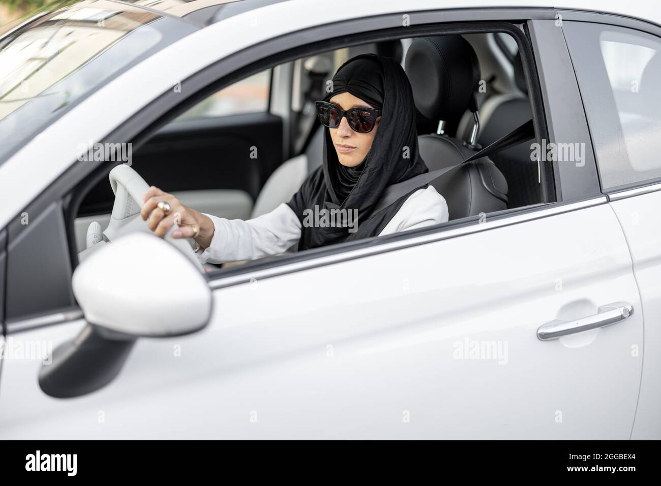 Muslim woman drives a car Stock Photo - Alamy