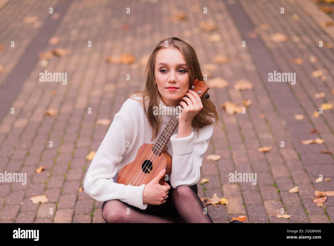 Beautiful girl playing ukulele hi-res stock photography and images - Alamy