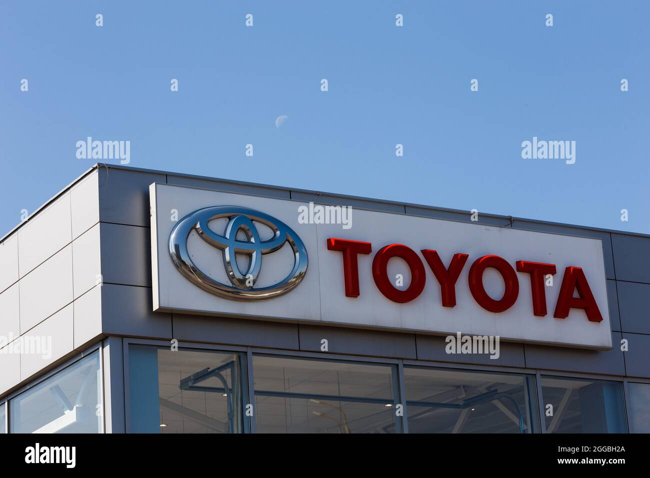 Toyota logo on car dealership building at sunny day - Toyota Motor ...