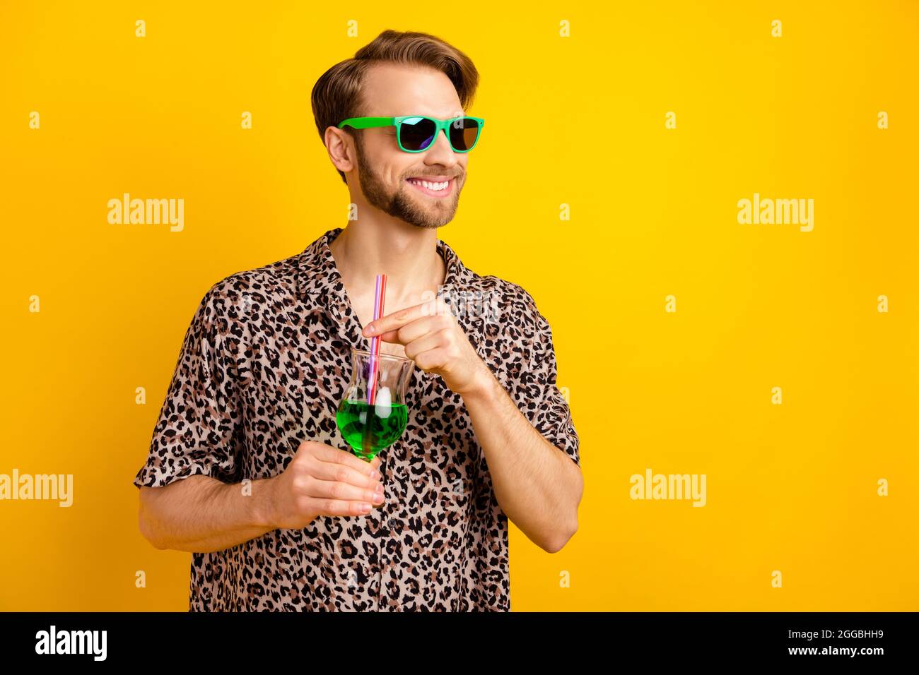 Photo of sweet charming guy wear leopard outfit dark eyewear drinking ...