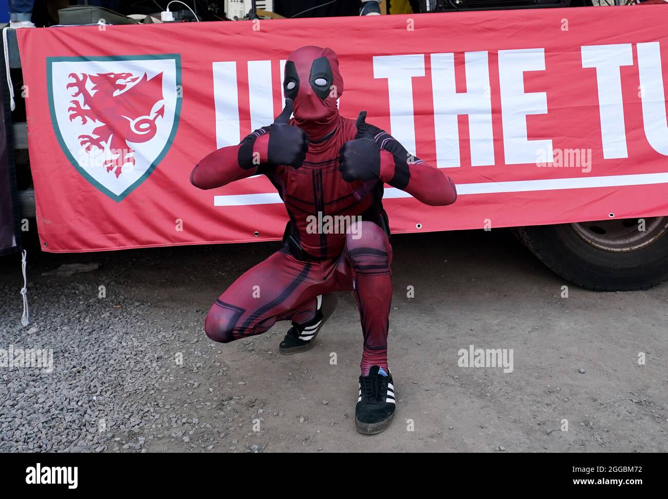 A person dressed as Deadpool entertains Wrexham fans outside the ...