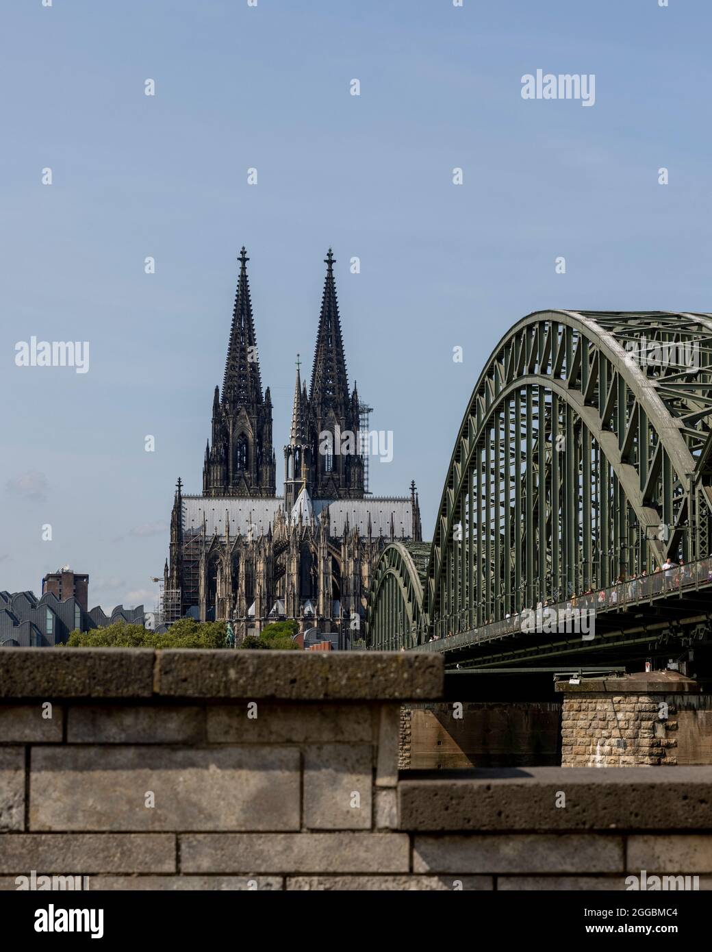 Cologne cathedral and incidental people in late summer overcast day ...