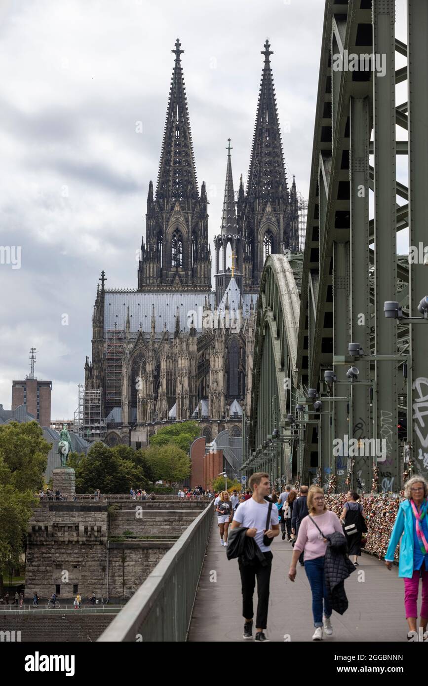 Cologne cathedral and incidental people in late summer overcast day ...