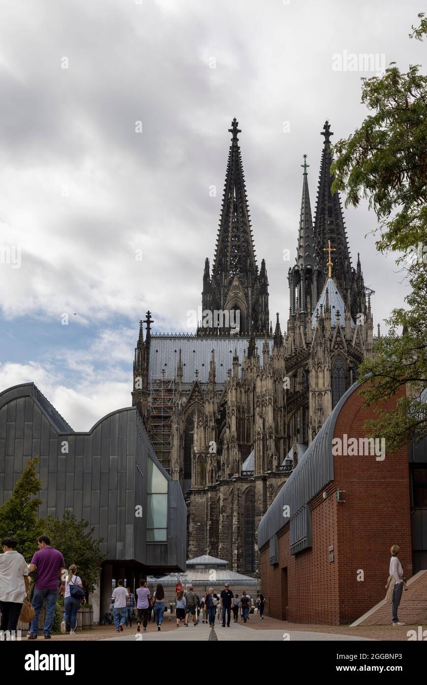 Cologne cathedral and incidental people in late summer overcast day ...