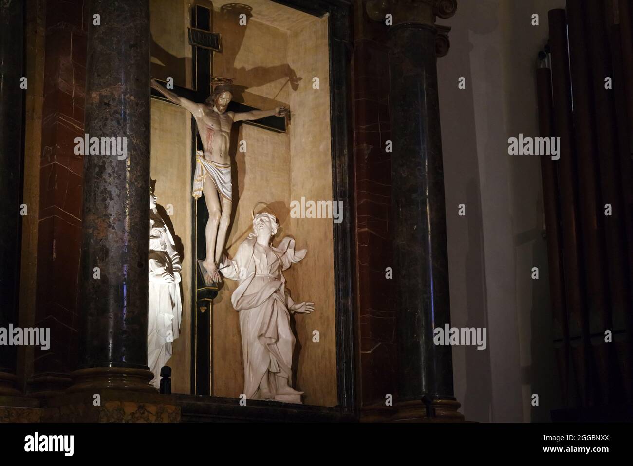 Christ in a cross and religious sculptures inside an old church Stock ...