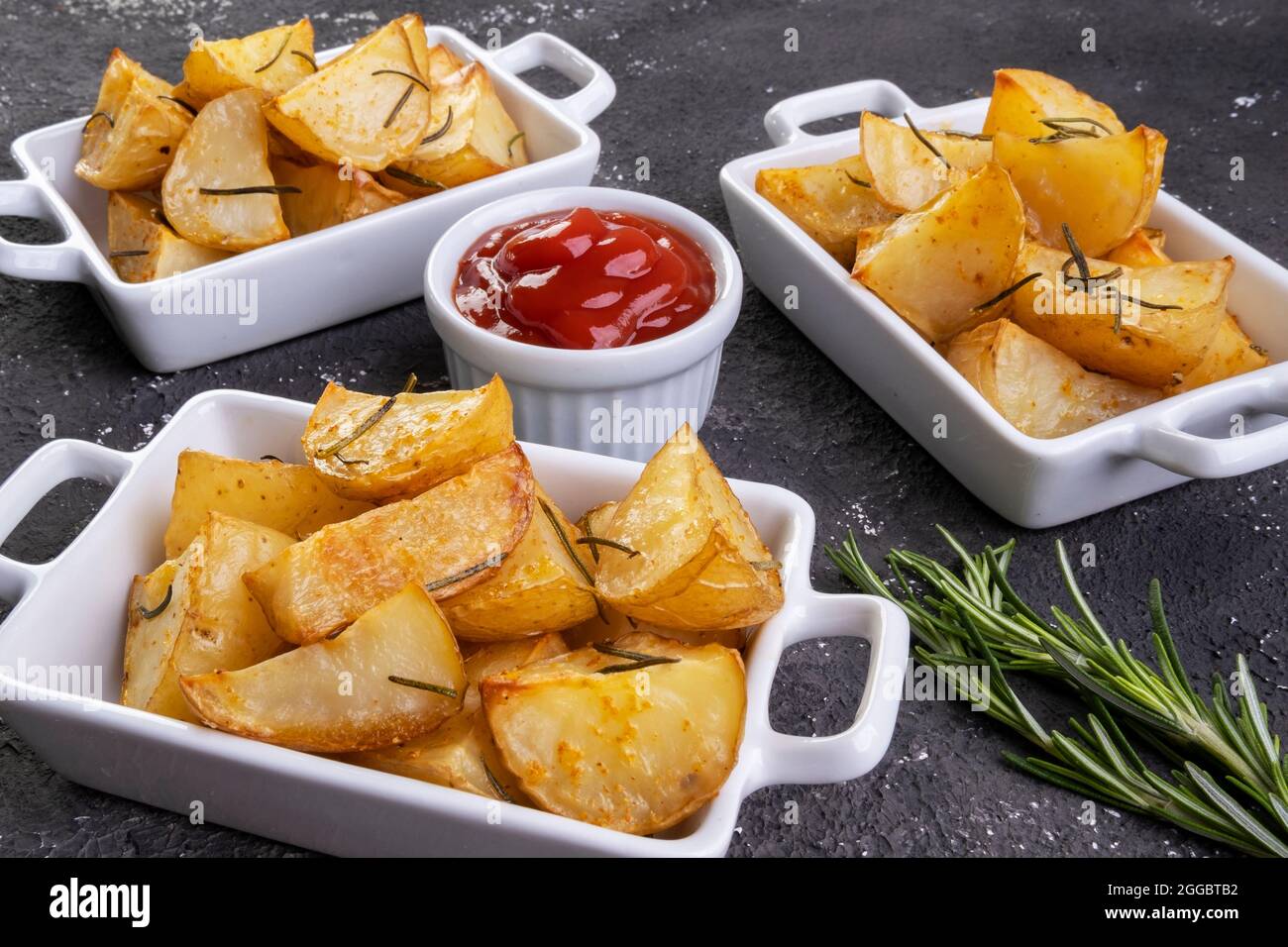 bowl of rustic fried and roasted potatoes with rosemary Stock Photo - Alamy