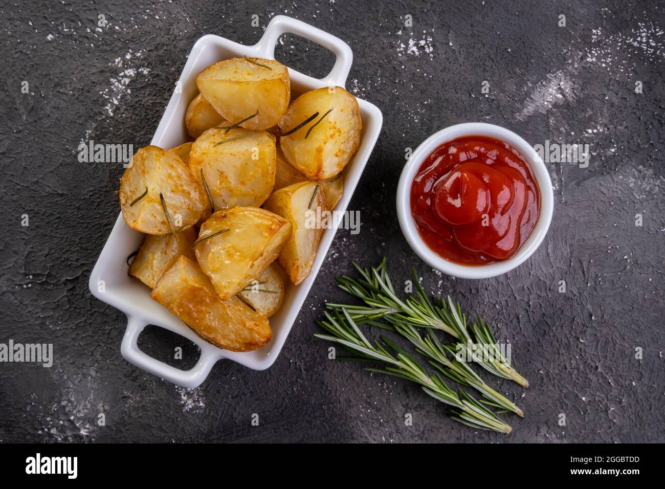 bowl of rustic fried and roasted potatoes with rosemary Stock Photo - Alamy