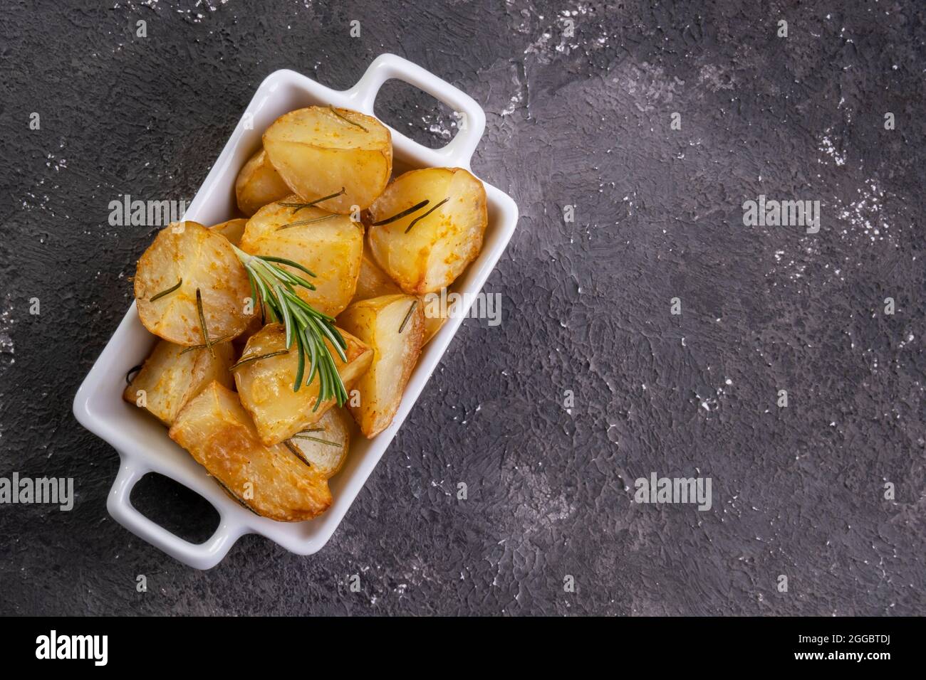 bowl of rustic fried and roasted potatoes with rosemary Stock Photo - Alamy