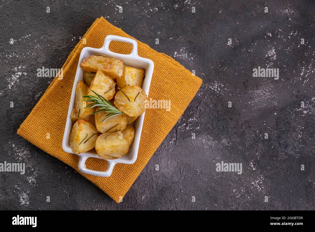 bowl of rustic fried and roasted potatoes with rosemary Stock Photo - Alamy