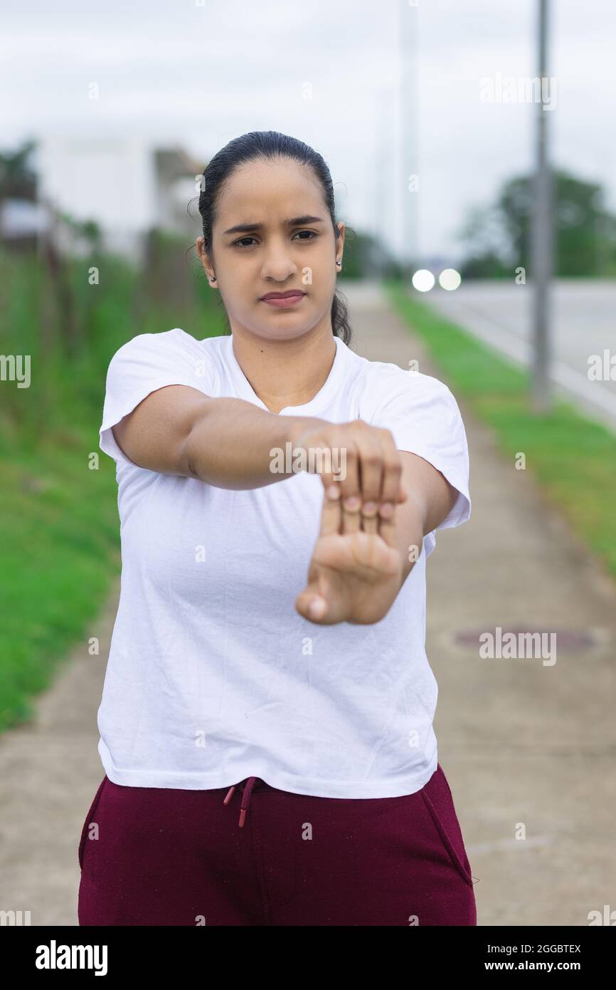 Vertical closeup of a girl doing finger-stretching outdoors Stock Photo ...
