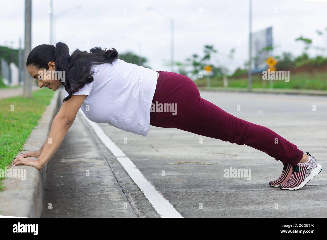 Closeup of a girl doing push-ups outdoors Stock Photo - Alamy