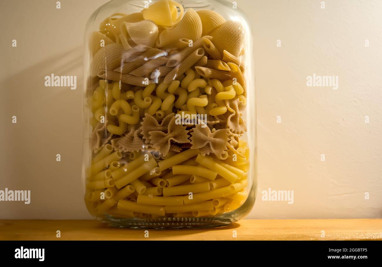 Pasta mix in a glass jar. Lumaconi, Penne, Cavatappi, Farfalle and ...