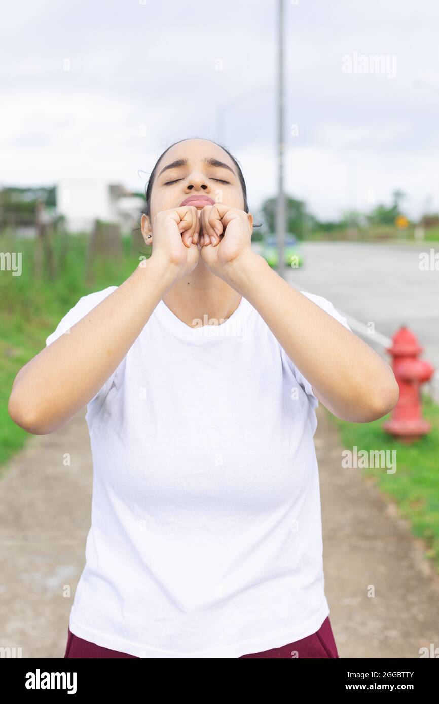 Vertical closeup of a girl doing neck lift outdoors Stock Photo - Alamy