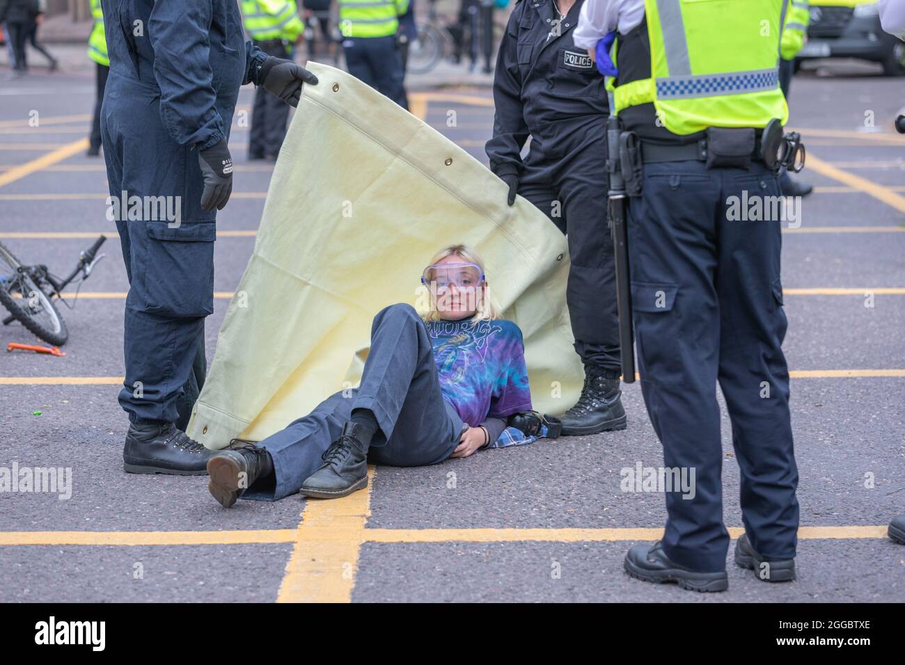 London, UK. 30th Aug 2021. Extinction Rebellion activist is protected ...