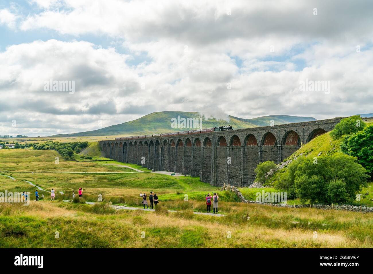 RIBBLEHEAD, UK - AUGUST 24, 2021: Train spotters watch a steam train ...