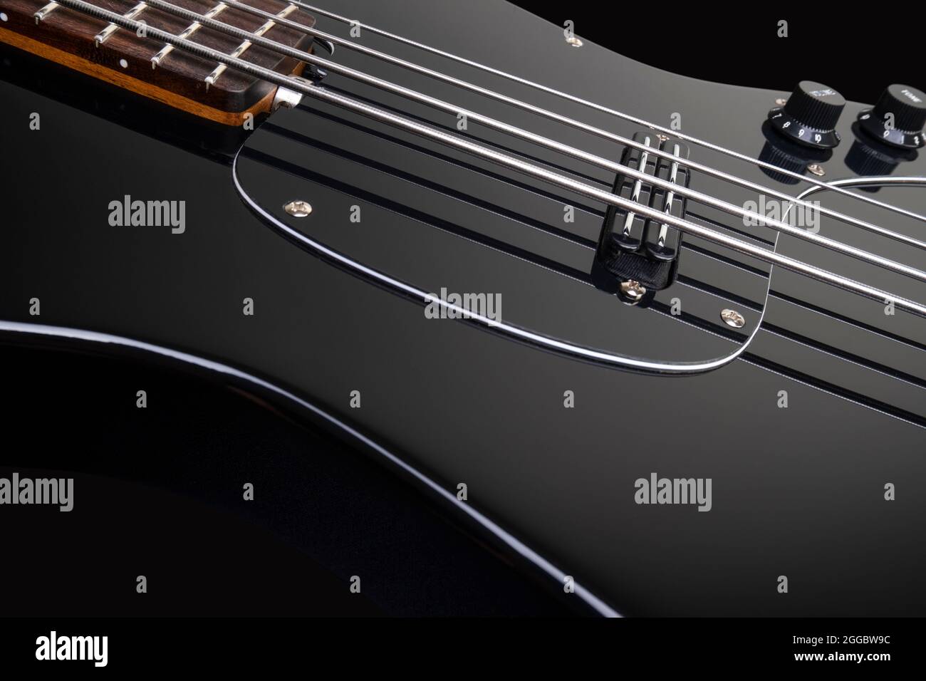 black bass guitar on black background Stock Photo - Alamy