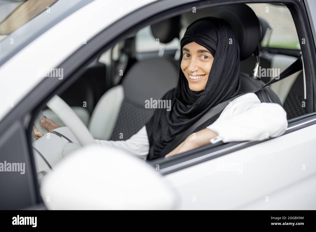 Muslim woman drives a car Stock Photo - Alamy