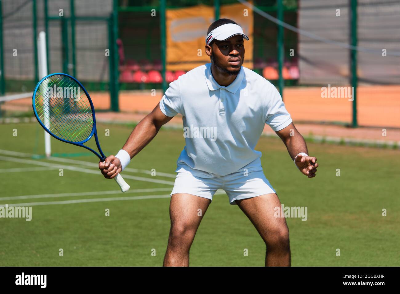 Focused african american sportsman playing tennis on court Stock Photo ...