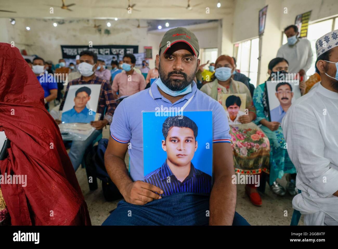 Relatives hold portraits of disappeared family members at an event to ...