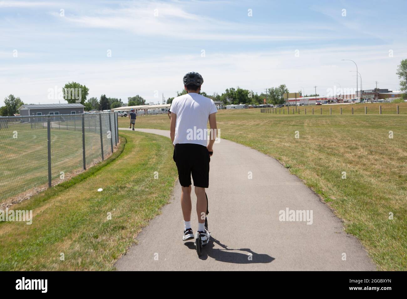 Man driving a kick scooter in a park Stock Photo - Alamy