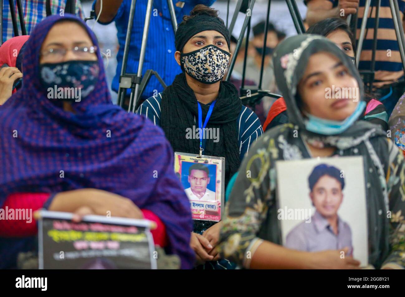 Relatives hold portraits of disappeared family members at an event to ...