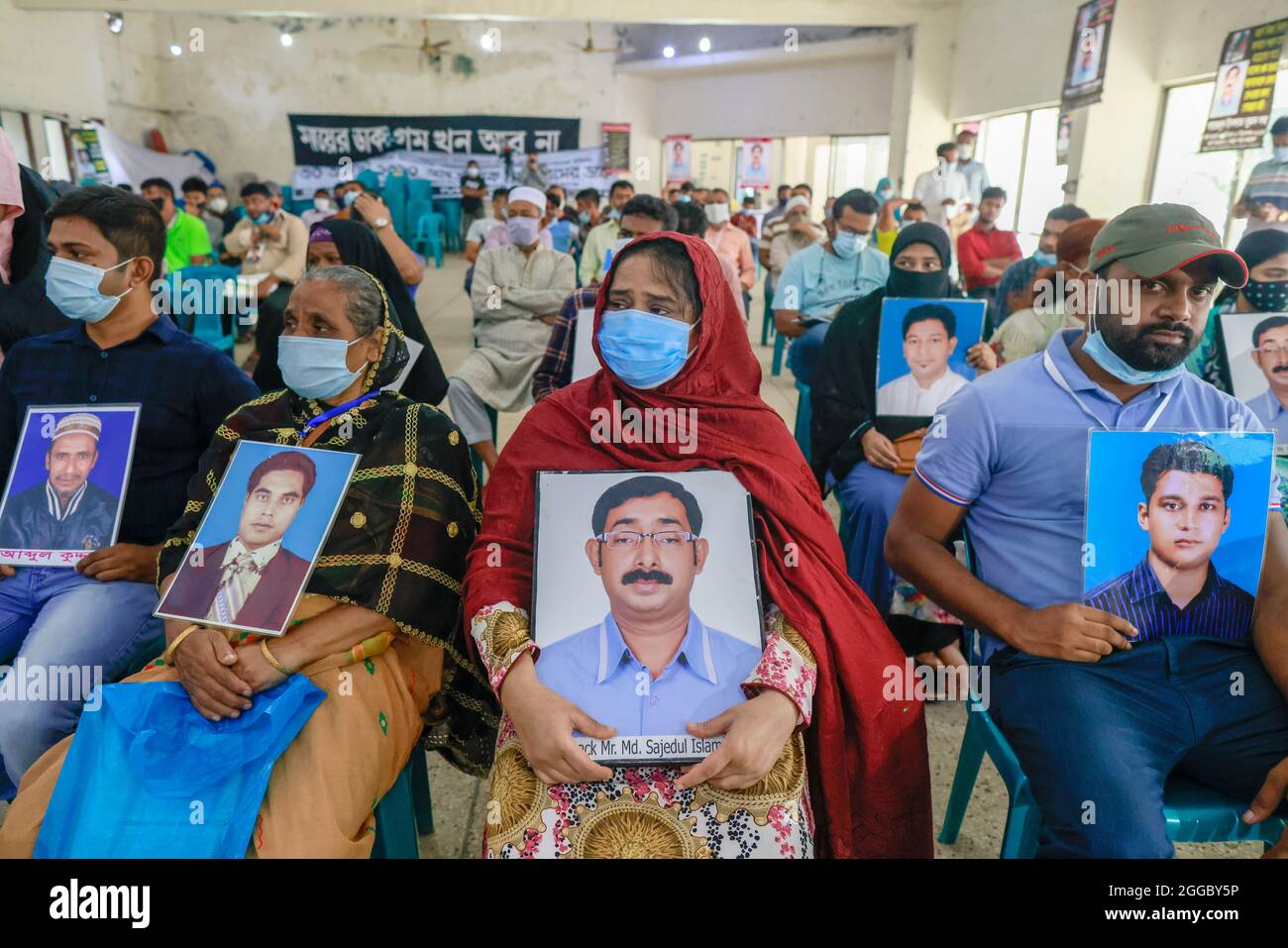 Relatives hold portraits of disappeared family members at an event to ...