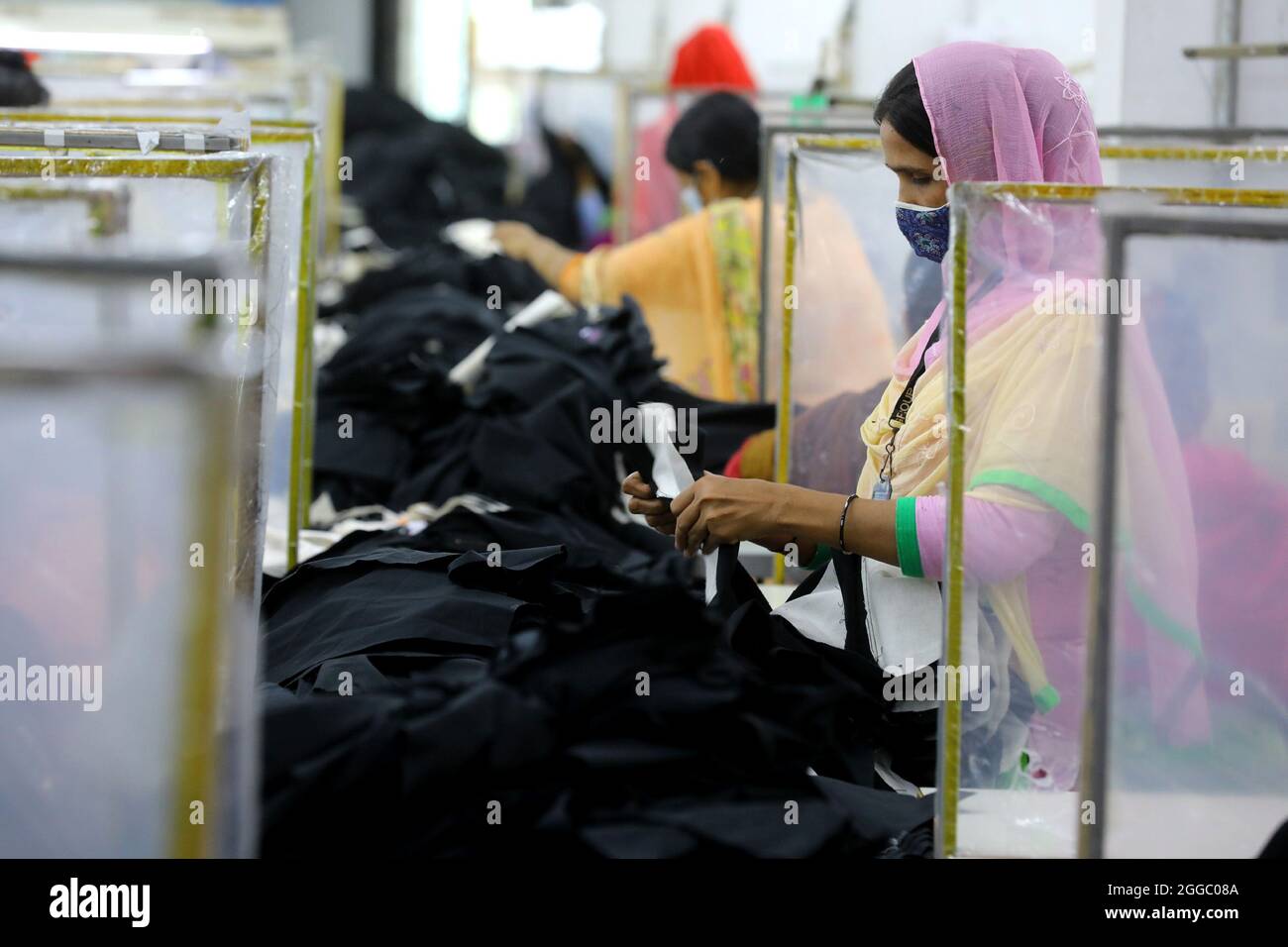 A Woman worker wears face mask as preventive measure while manufactures ...