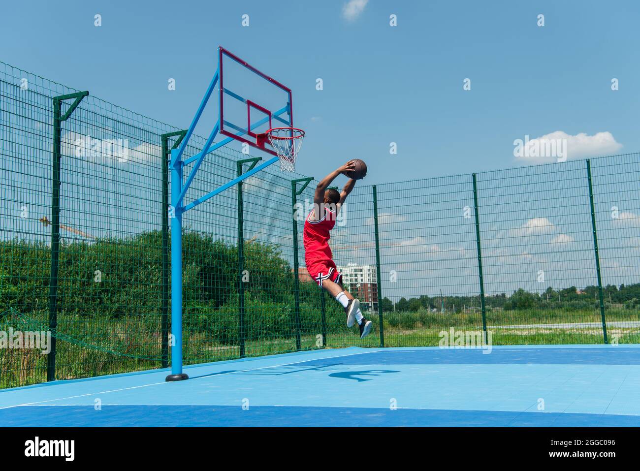 African american player jumping with basketball ball under hoop Stock ...