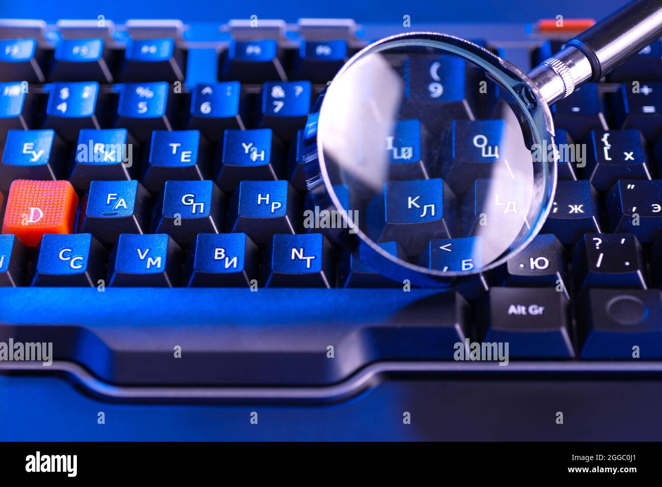 Magnifying glass on the keys of a black computer keyboard Stock Photo ...