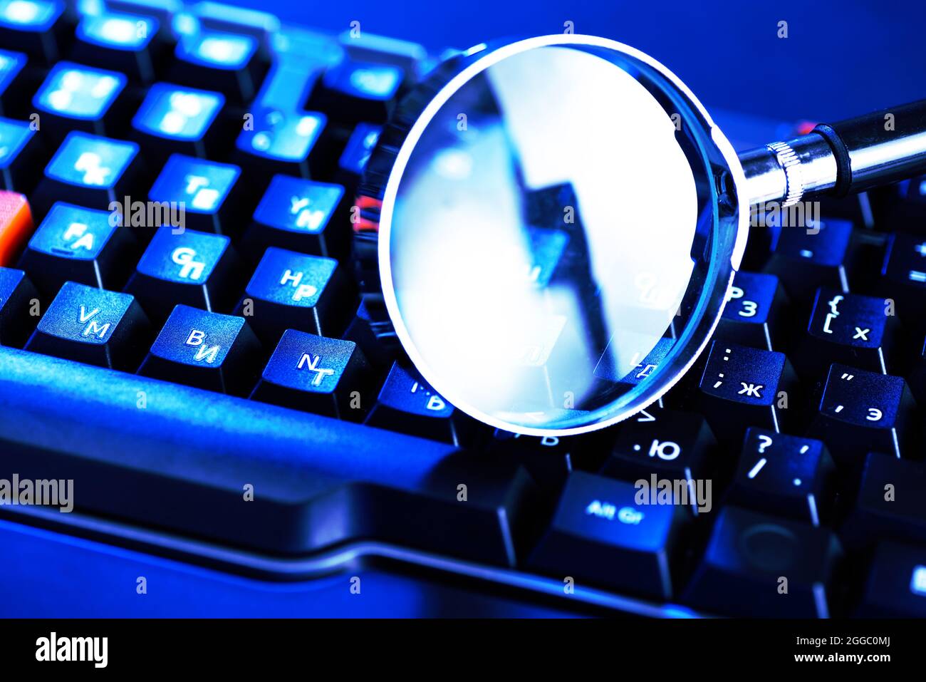 Magnifying glass on the keys of a black computer keyboard Stock Photo ...