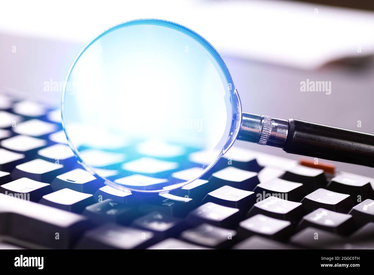 Magnifying glass on the keys of a black computer keyboard Stock Photo ...