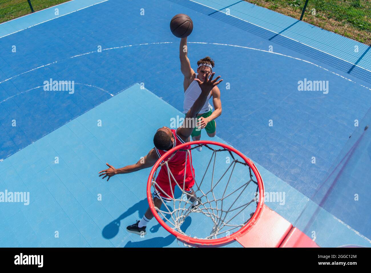 Overhead view of multiethnic sportsmen playing streetball Stock Photo ...