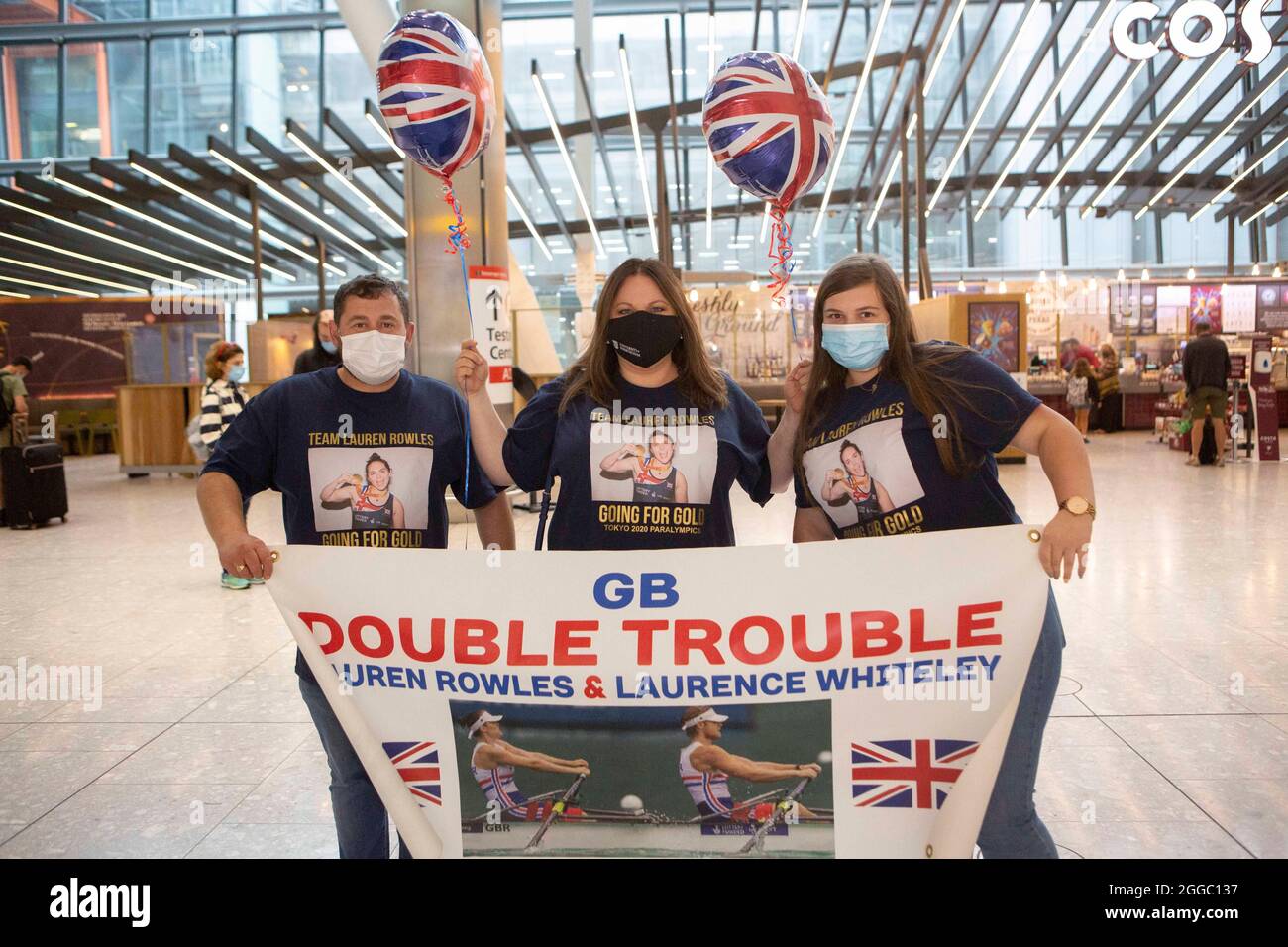 Gold medalist Lauren Rowles' family wait for her arrival back at London ...