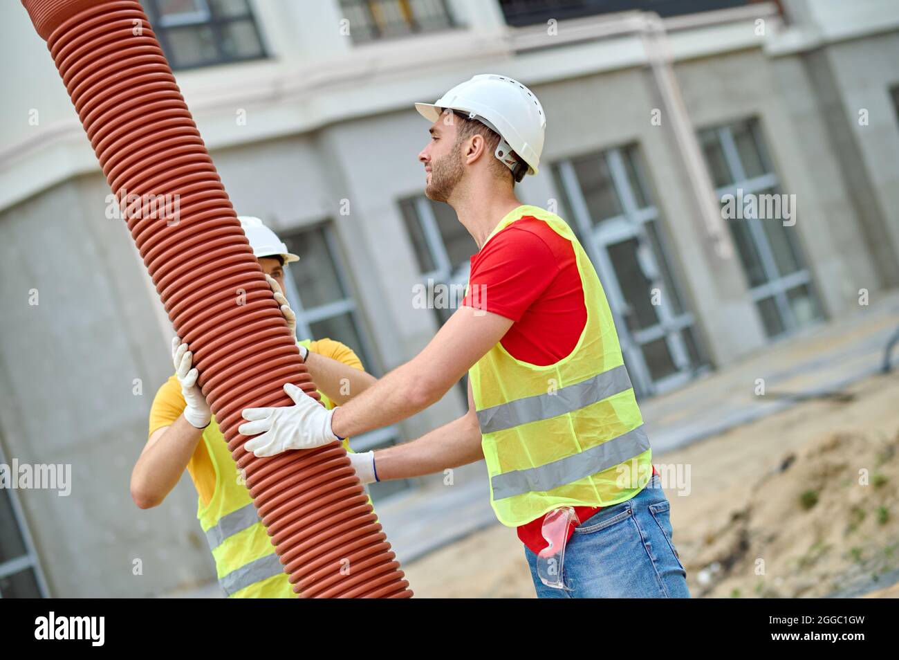 Skilled workers carrying out a residential sewer line installation ...