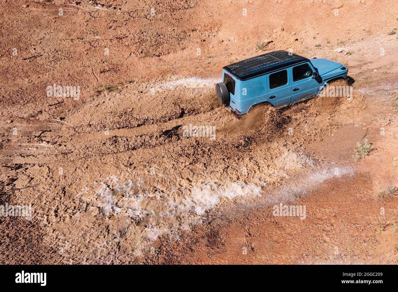 4x4 vehicle in full action going through a large puddle of water and ...