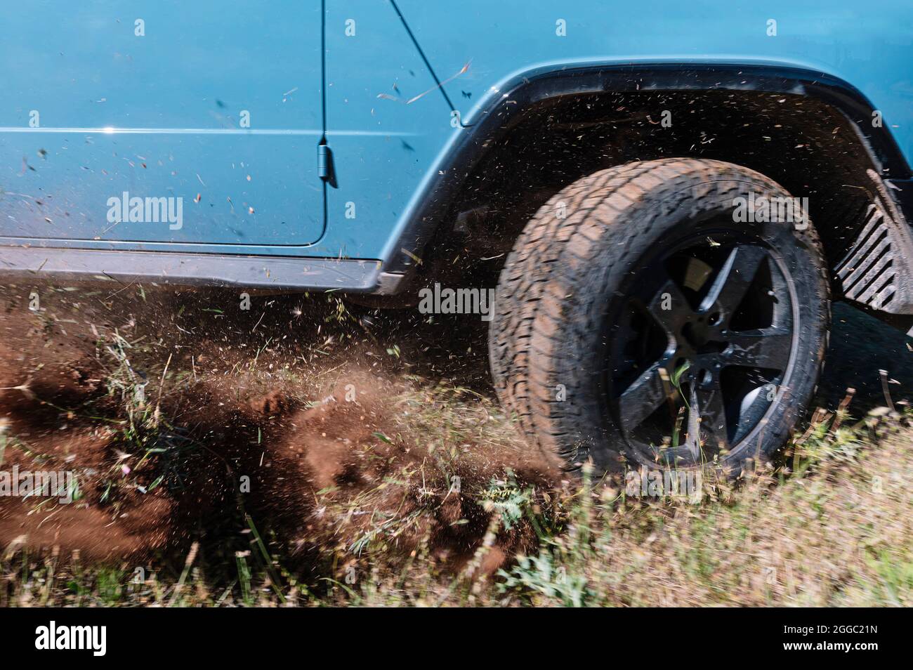 Close-up tire of a 4x4 vehicle in full action, Splashing mud and water ...