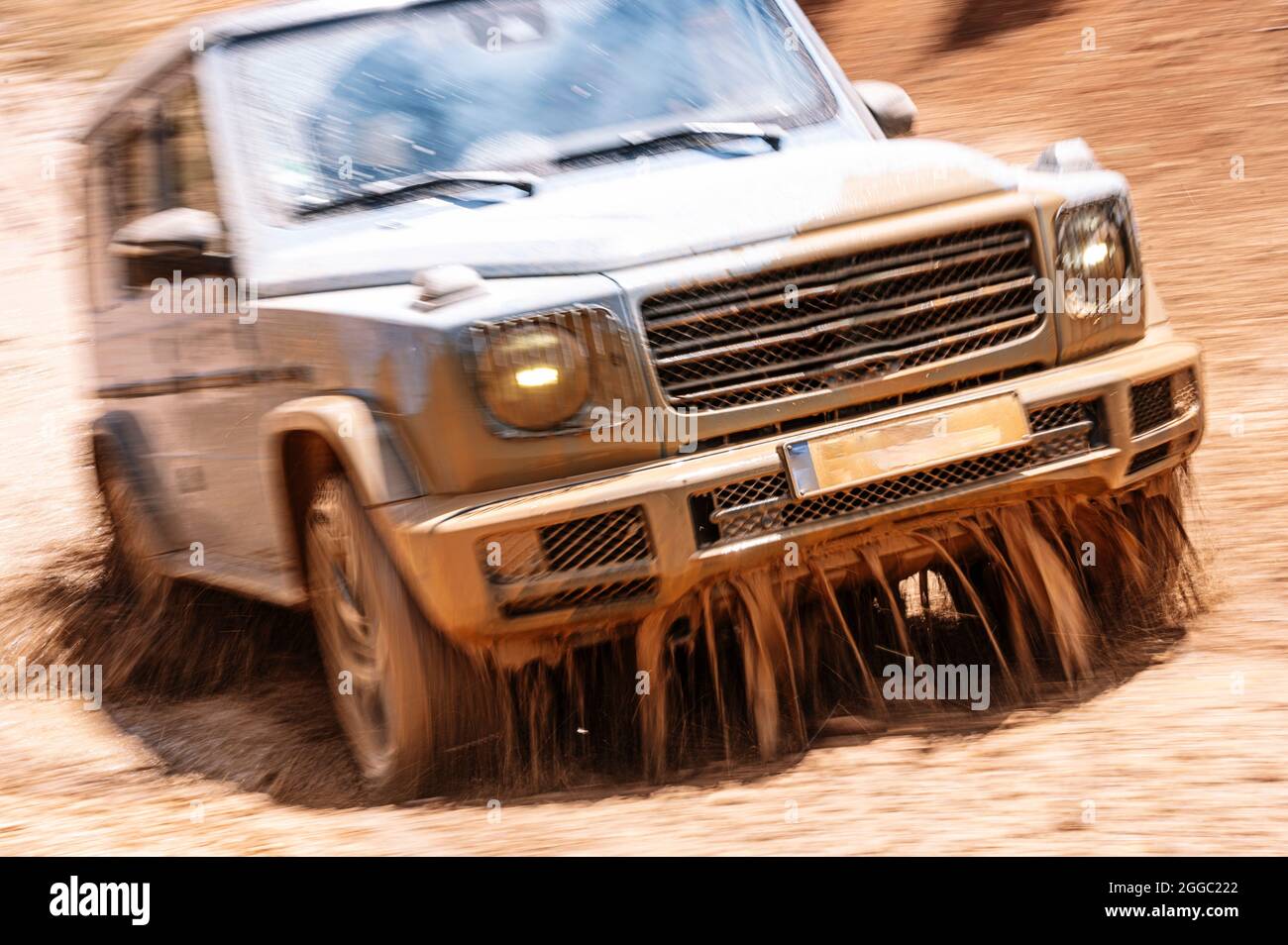 4x4 vehicle in full action going through a large puddle of water and ...