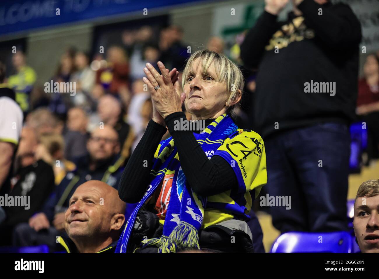 A Warrington fan celebrates after George Williams (31) of Warrington ...
