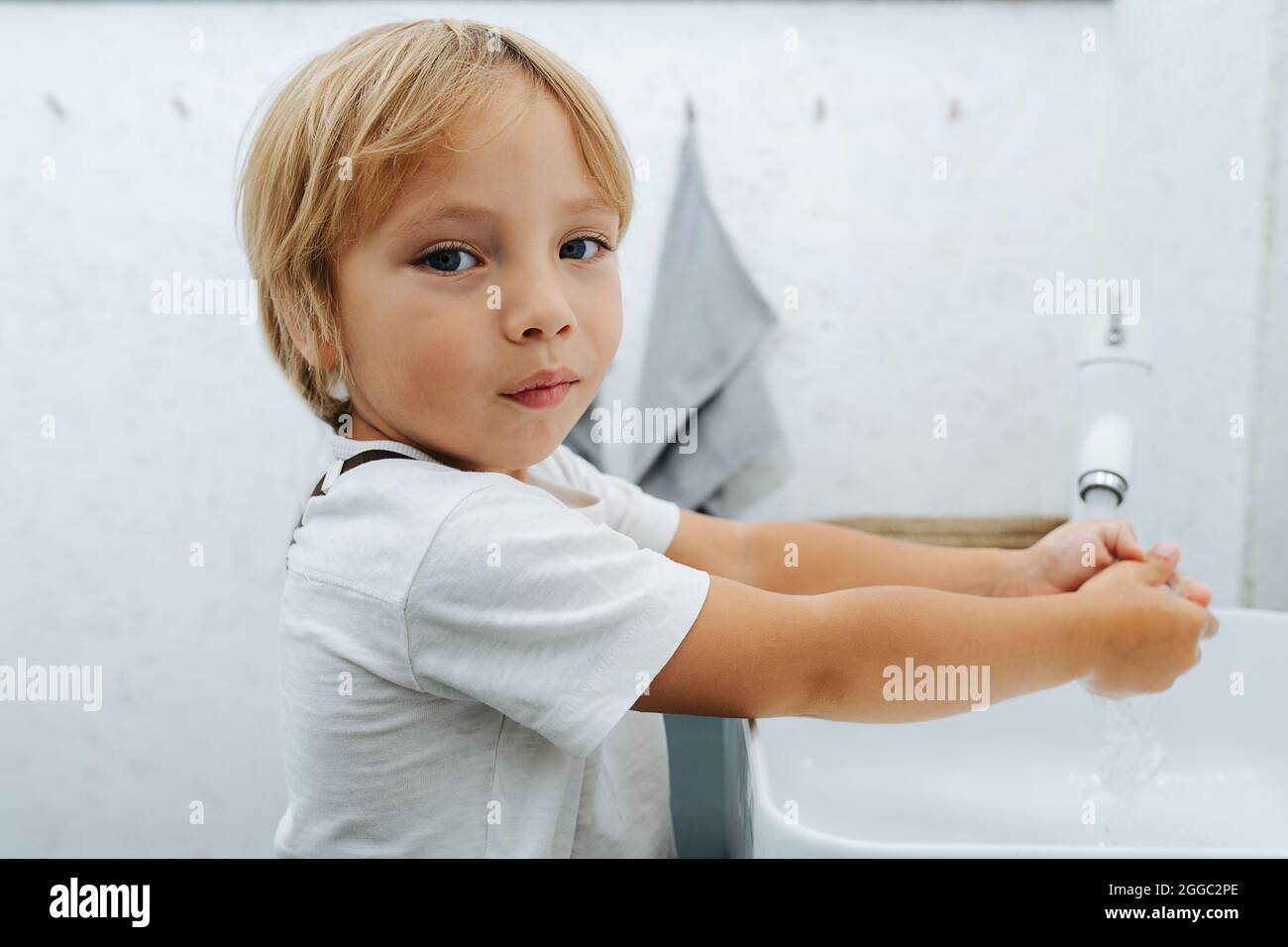Caucasian boy washing face at sink hi-res stock photography and images ...