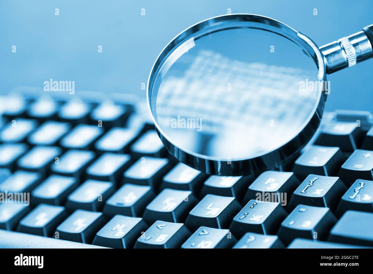 Magnifying glass on the keys of a black computer keyboard Stock Photo ...