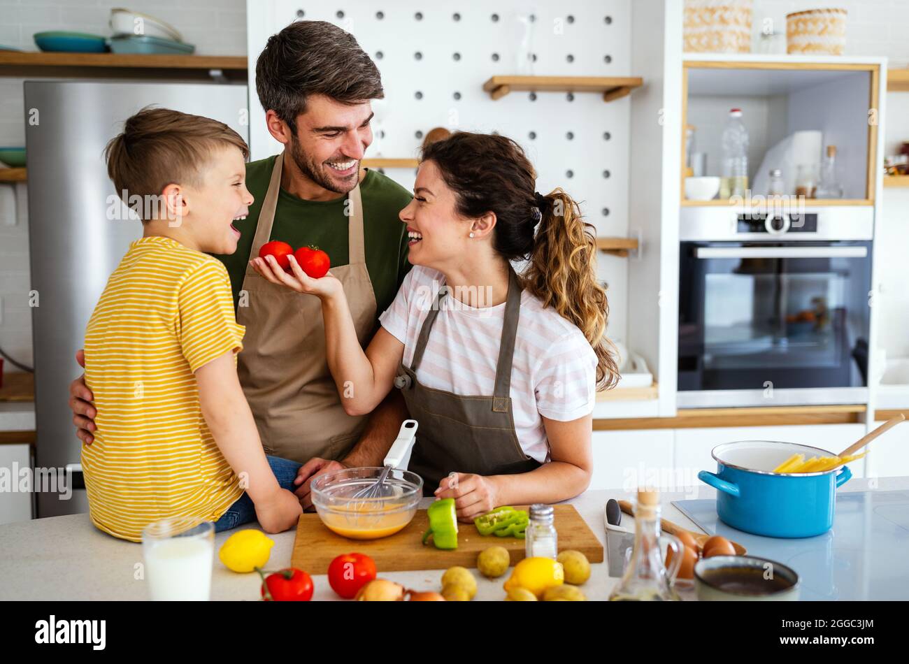 Happy family in the kitchen having fun and cooking together. Healthy ...