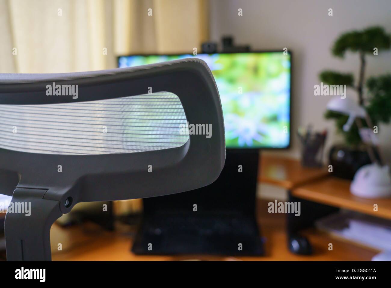 looking over the neck headrest of a modern ergonomic office chair ...